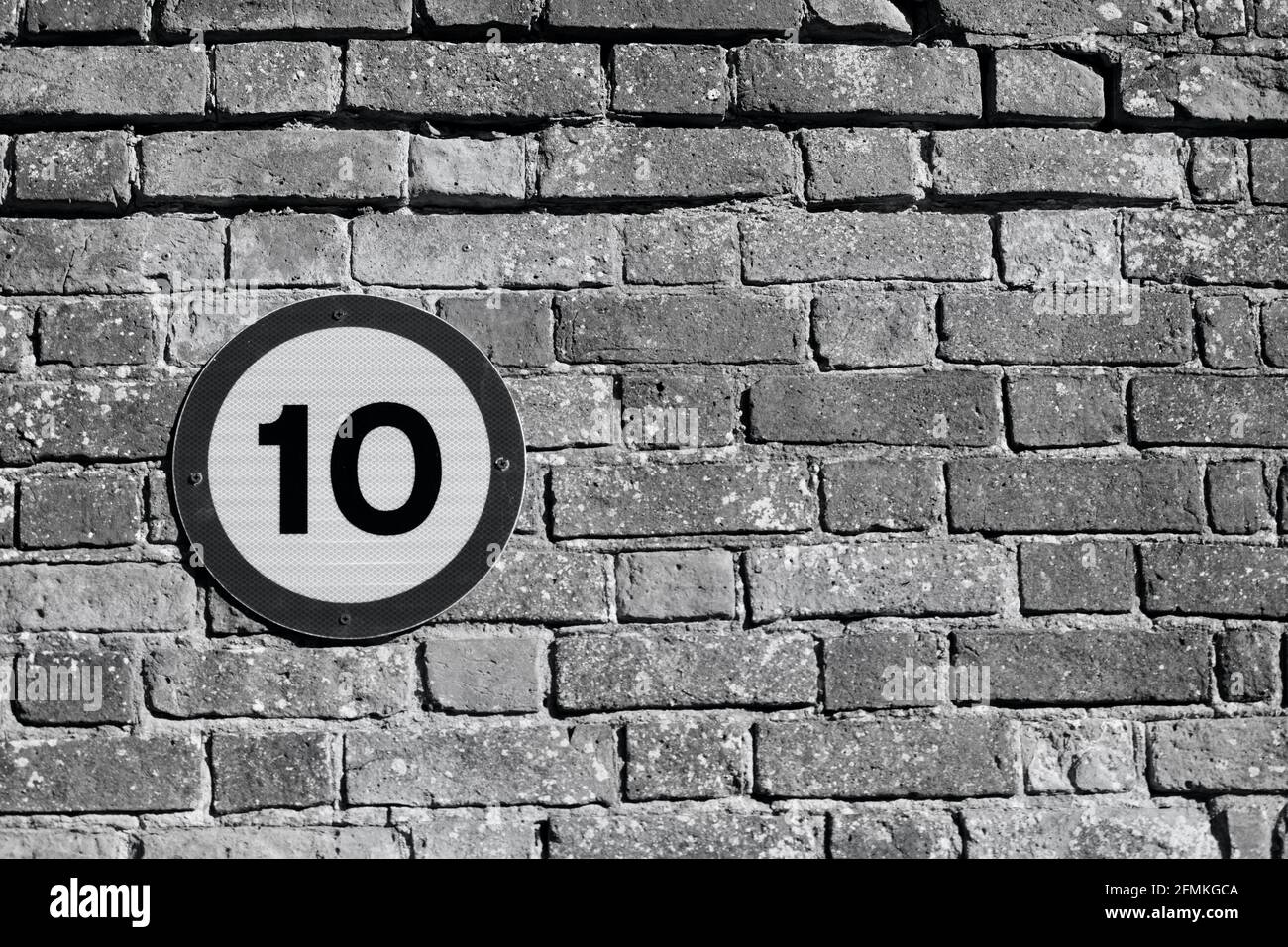 10 miles an hour traffic sign on an old brick background Stock Photo ...