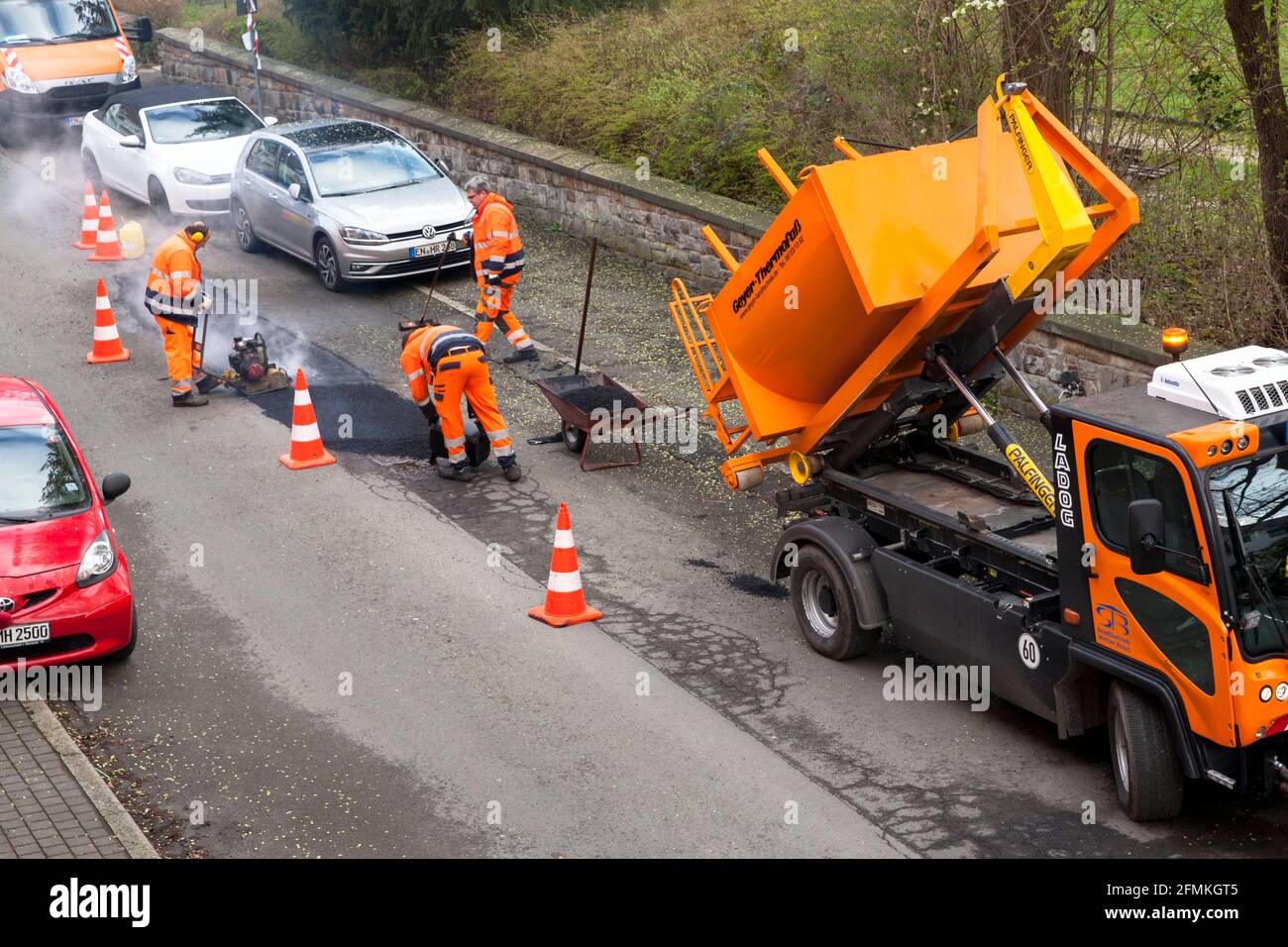 road repair works in the city of Wetter, filling of roadway damages ...