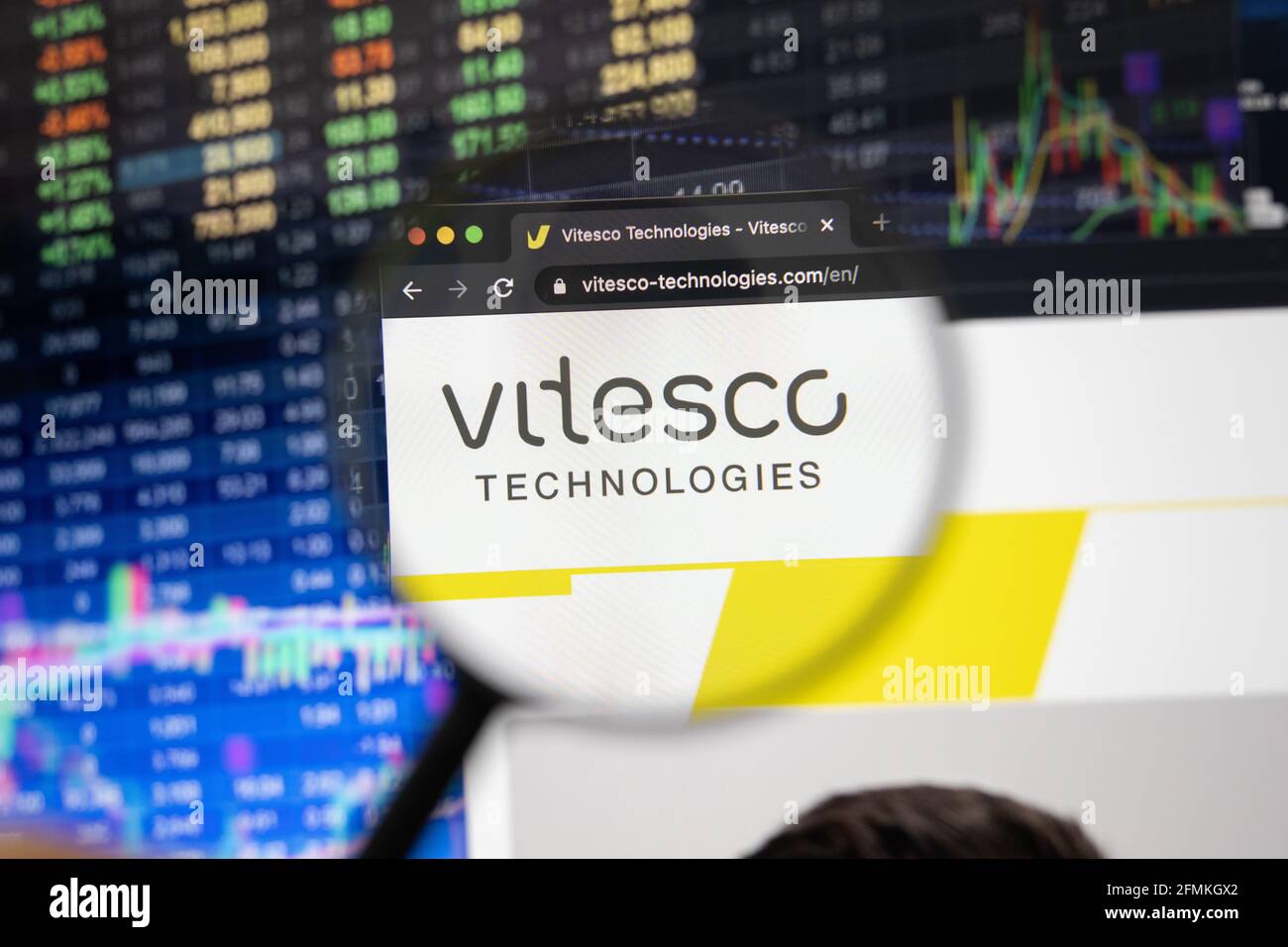 Vitesco Technologies company logo on a website with blurry stock market ...