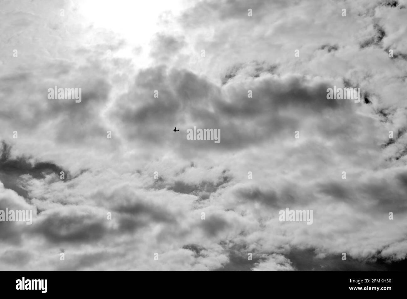 Flight training, small single engine plane ascends into a moody, stormy ...