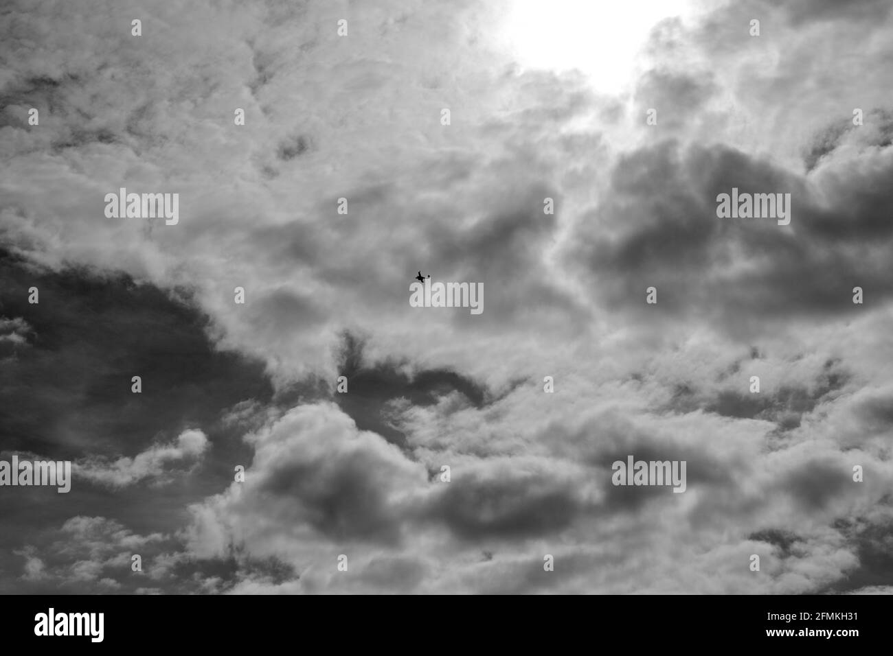 Flight training, small single engine plane ascends into a moody, stormy ...
