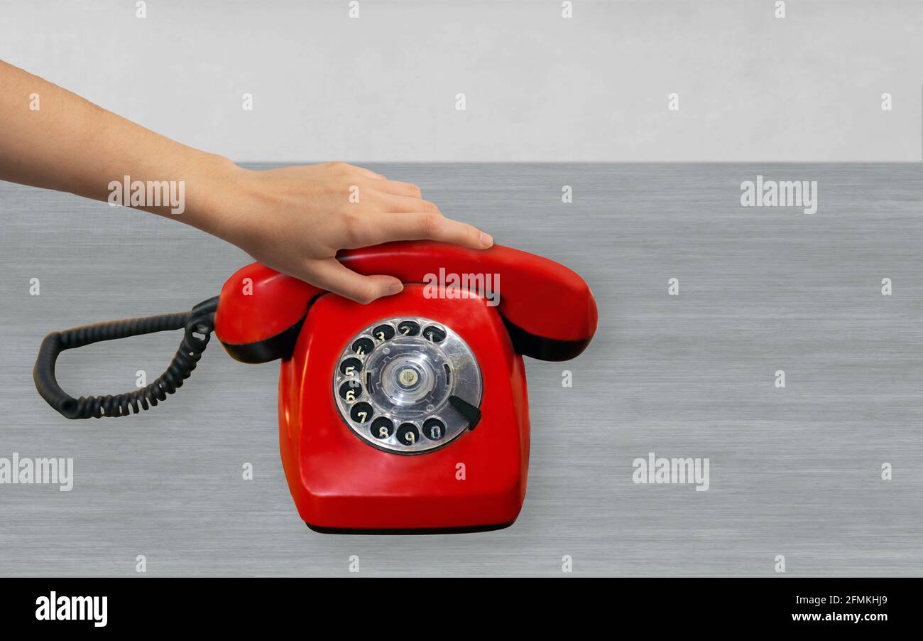 hand holding a red phone Stock Photo - Alamy