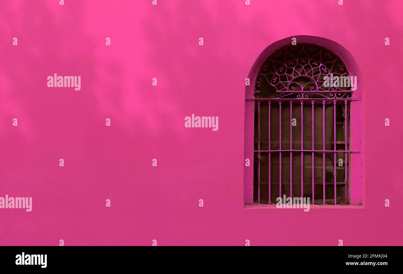 Hot pink wrought iron vintage window on french rose pink colored wall ...