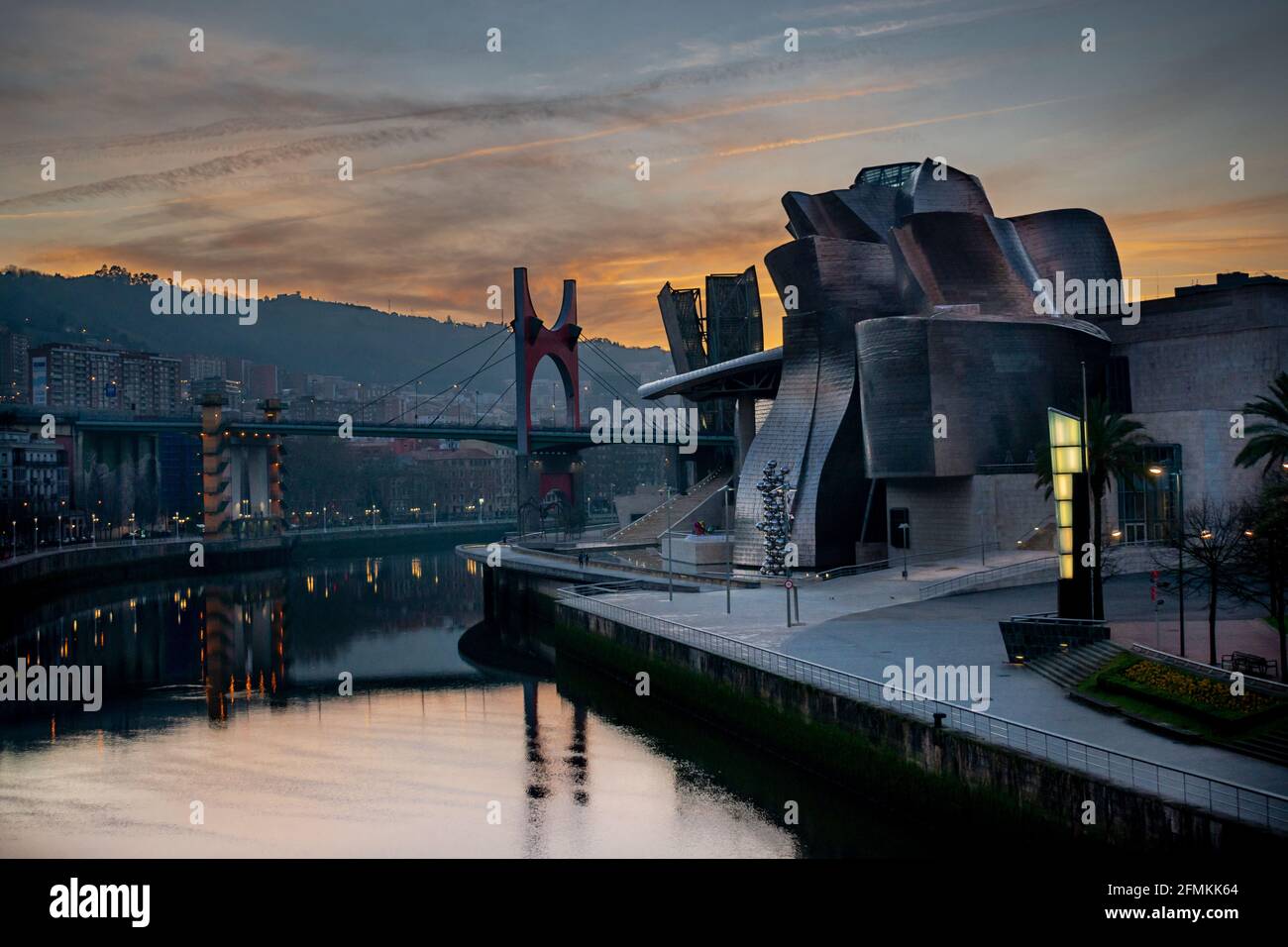 Panoramic exterior view of the Guggenheim museum in Bilbao at sunset ...
