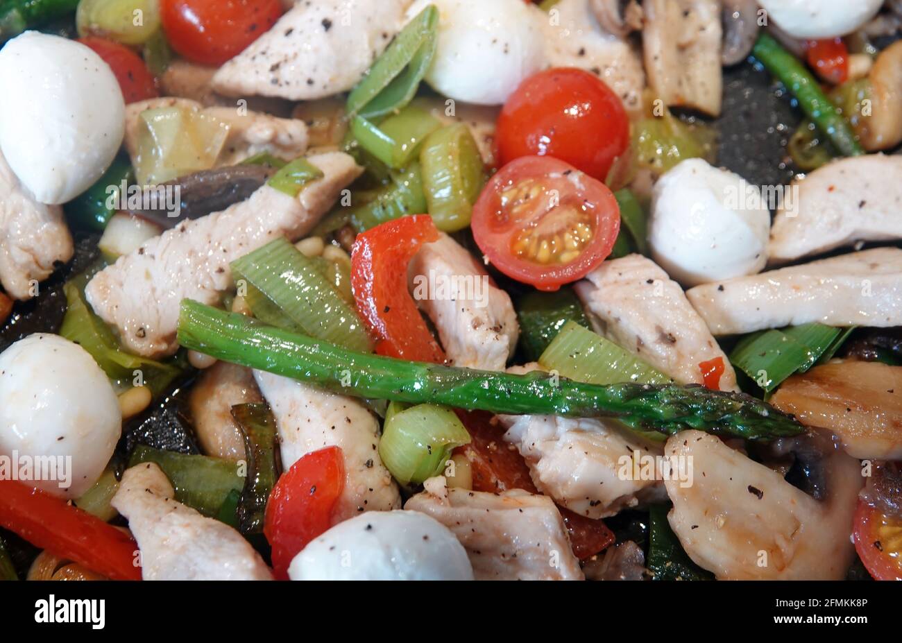 Delicious meal being cooked on a pan with chicken, mushrooms and ...