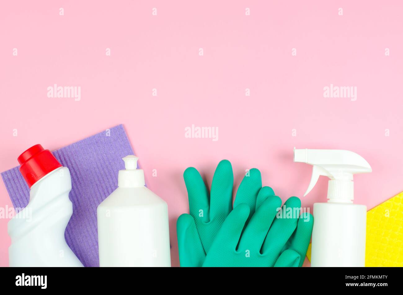 Cleaning products on a pink background. White bottles with detergents ...