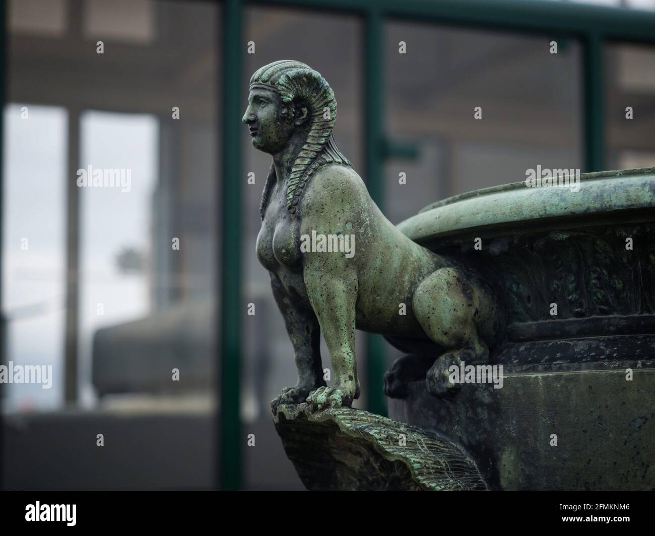 Closeup view of female head lion cat body sphinx figure statue bronze ...