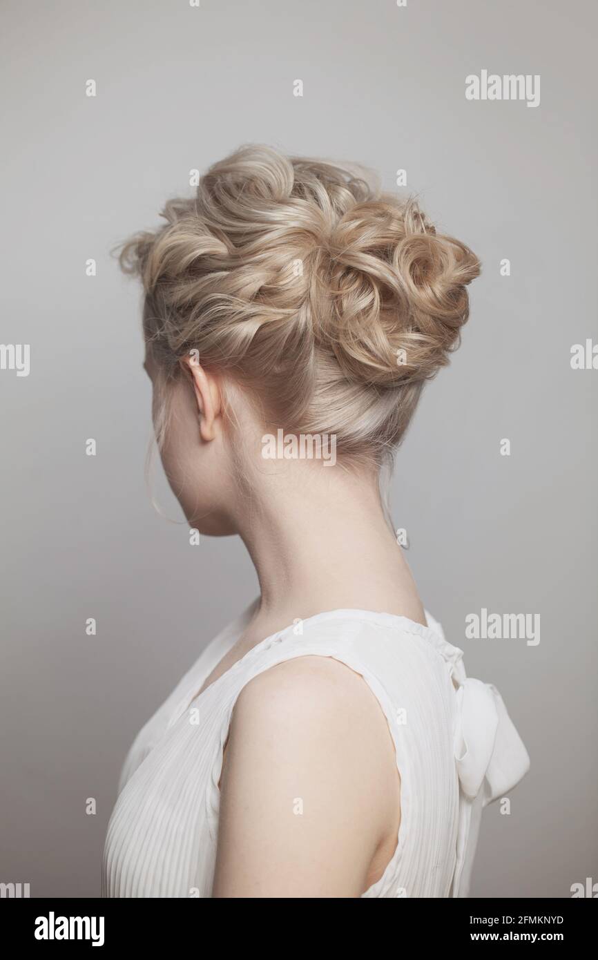 Woman blonde updo hairstyle on white background Stock Photo - Alamy