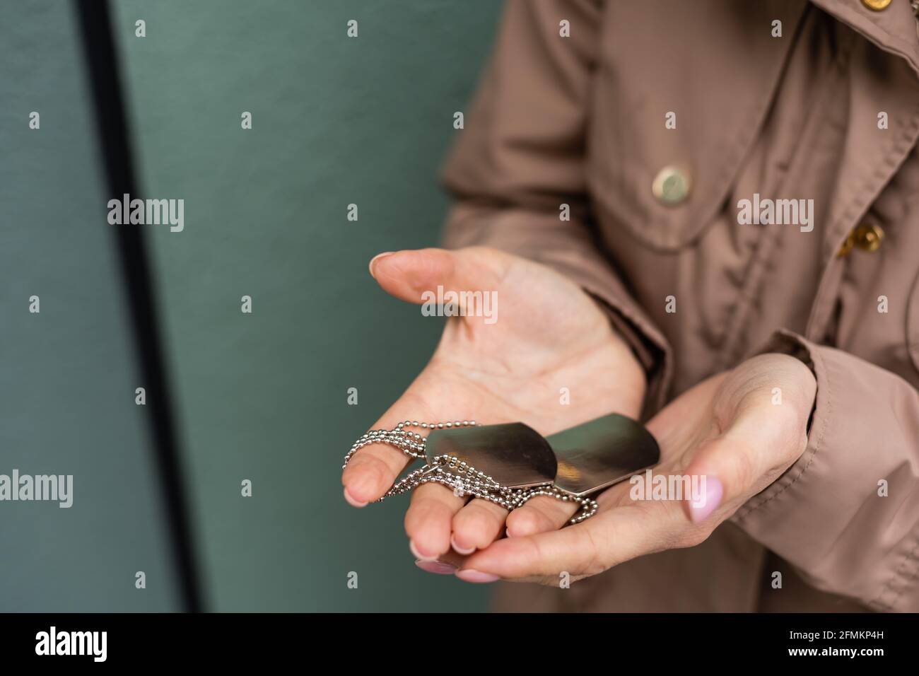 woman holding in hand military token Stock Photo - Alamy