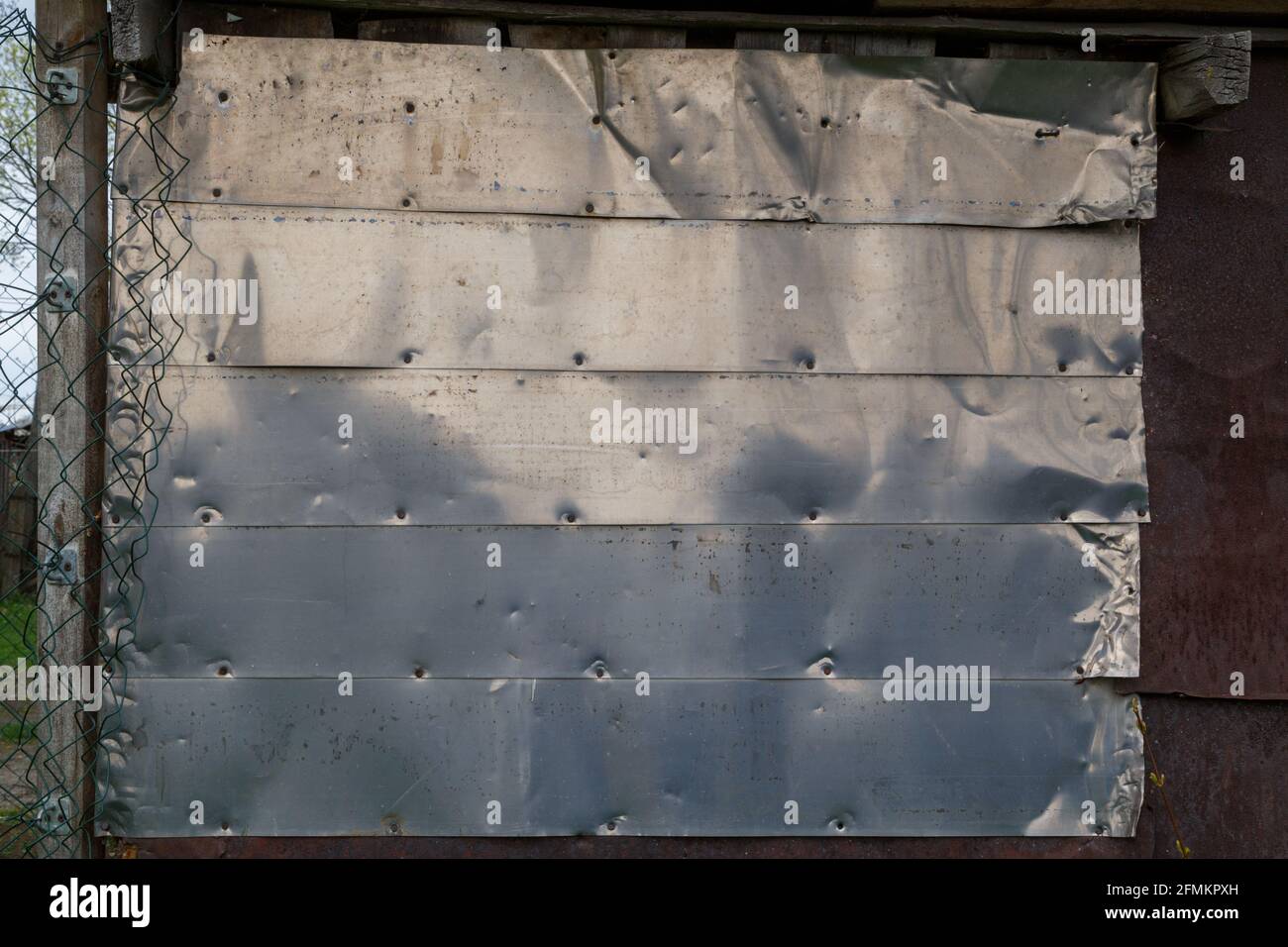 horizontal shiny stainless steel sheets nailed to flat surface - flat ...