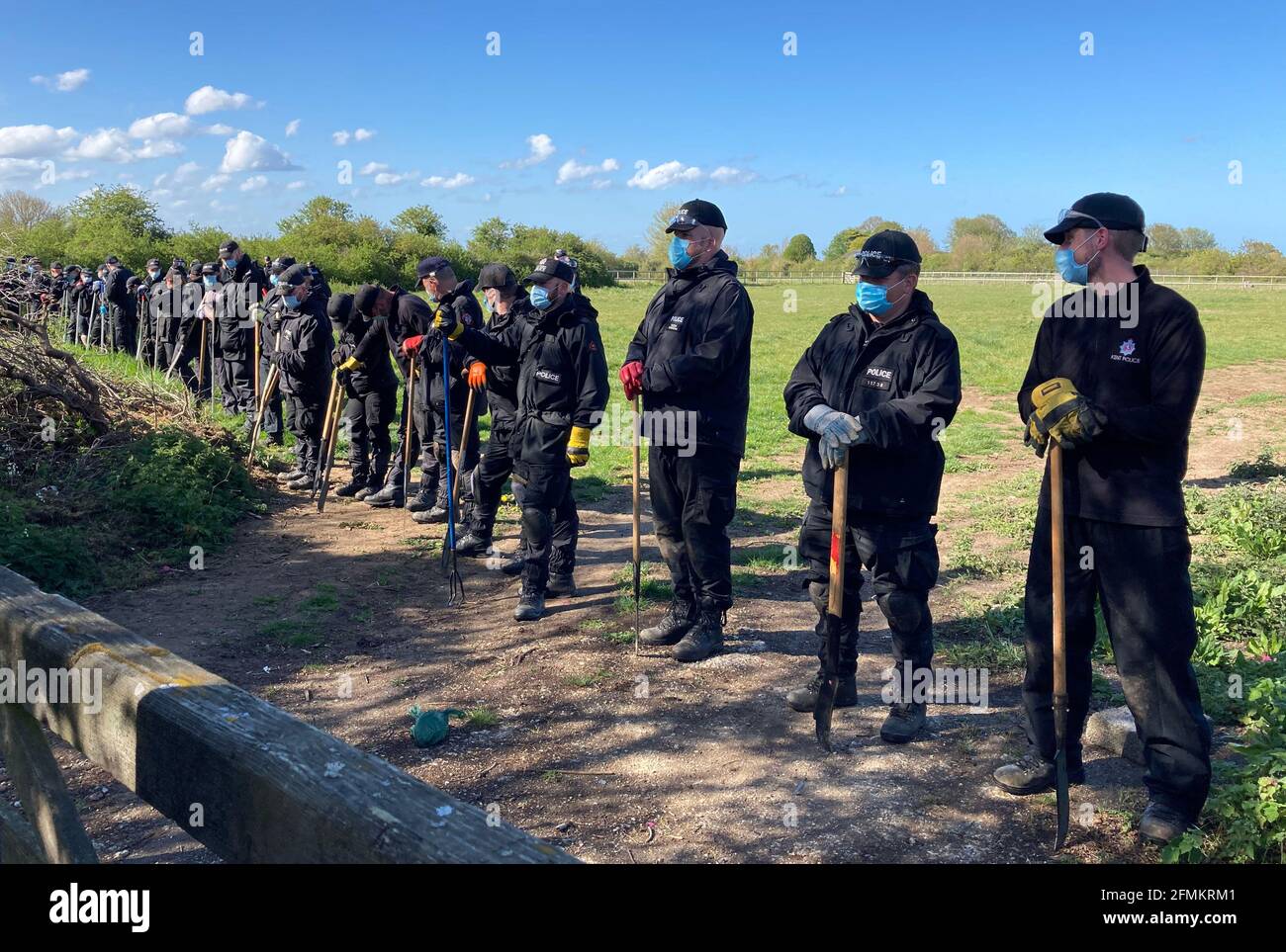 Police officers searching a field off Ratling Road in Aylesham, Kent ...
