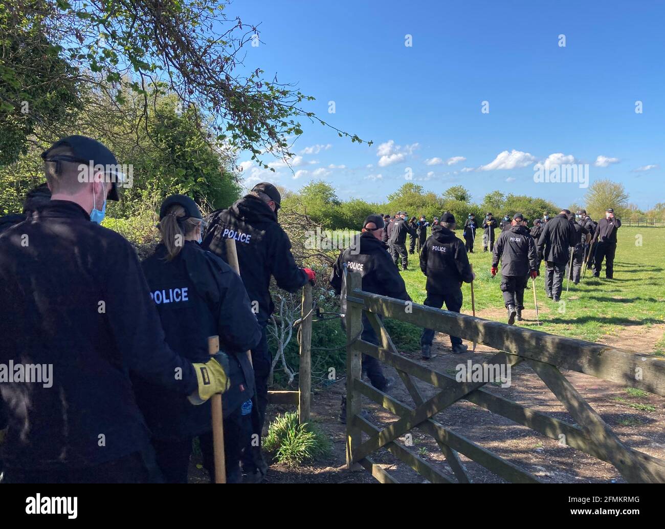 Police officers searching a field off Ratling Road in Aylesham, Kent ...