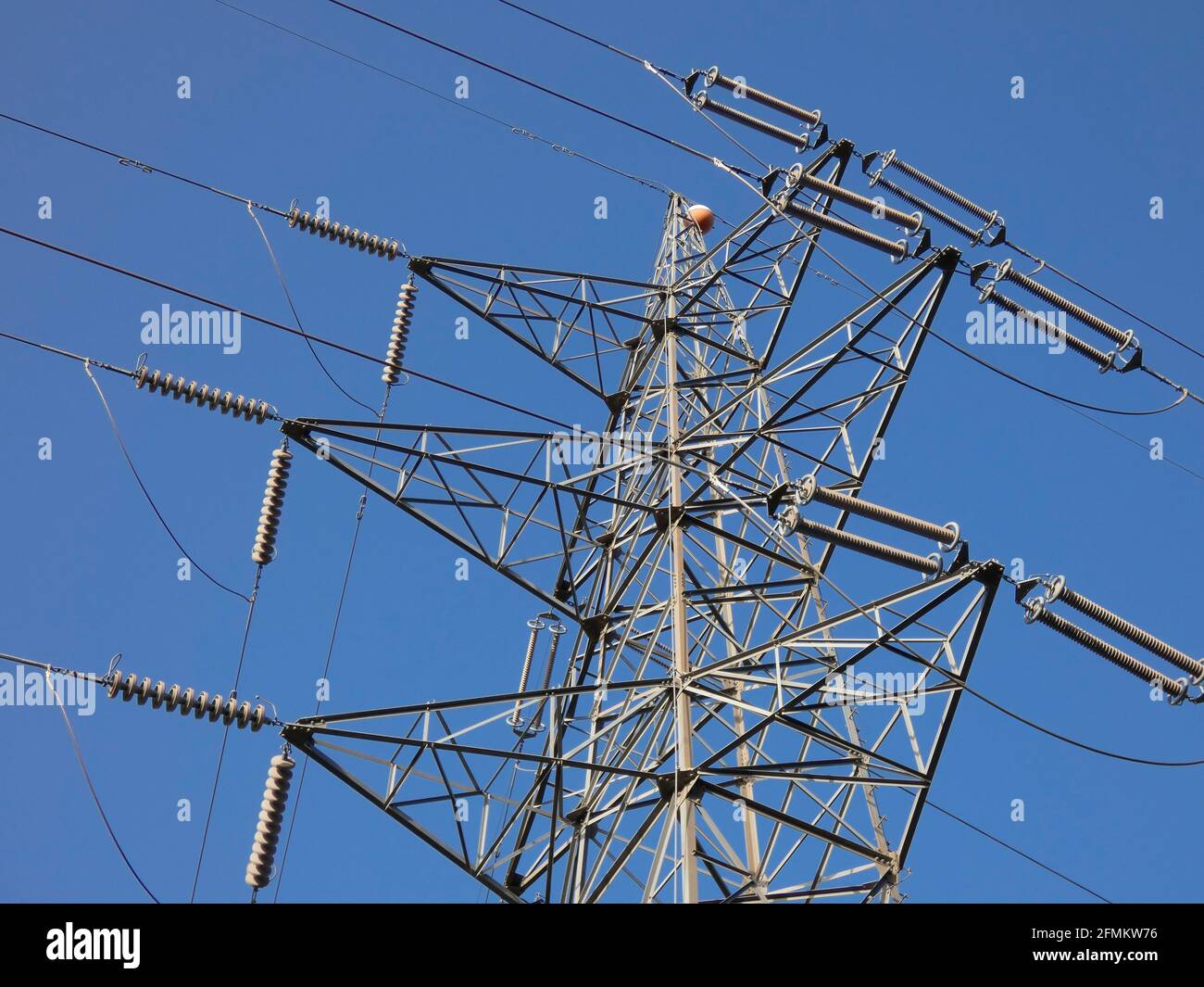 Metallic towers supporting the copper cables that carry electric power ...
