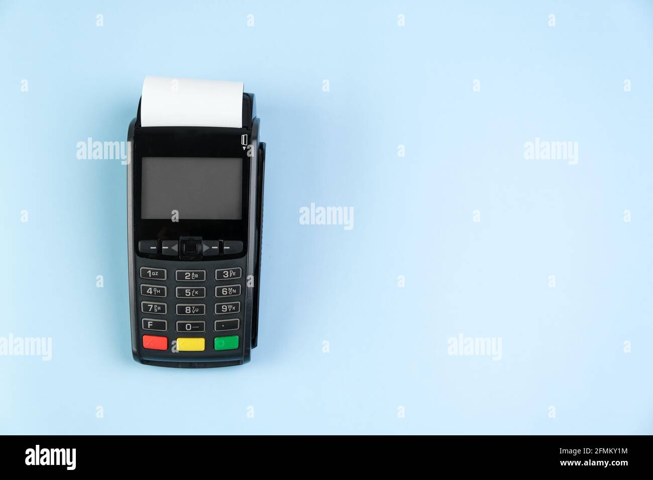 Payment terminal POS with a roll cash tape on the blue background with ...