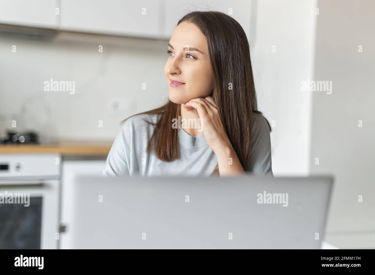 Remote work concept. Cheerful young woman using laptop computer for ...