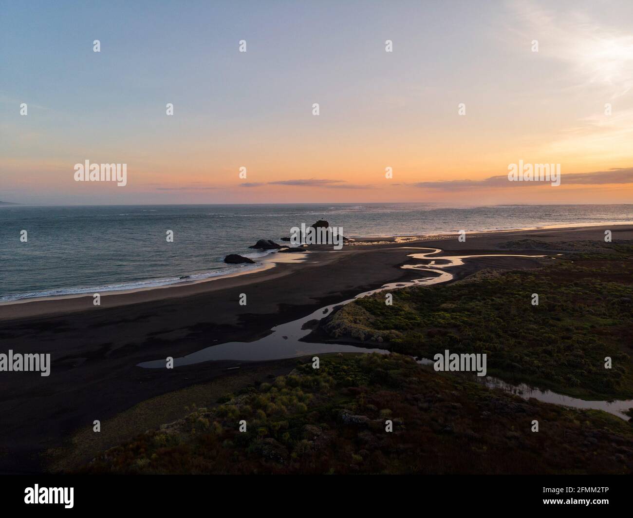 Aerial nature landscape sunset panorama at idyllic remote Whatipu beach ...