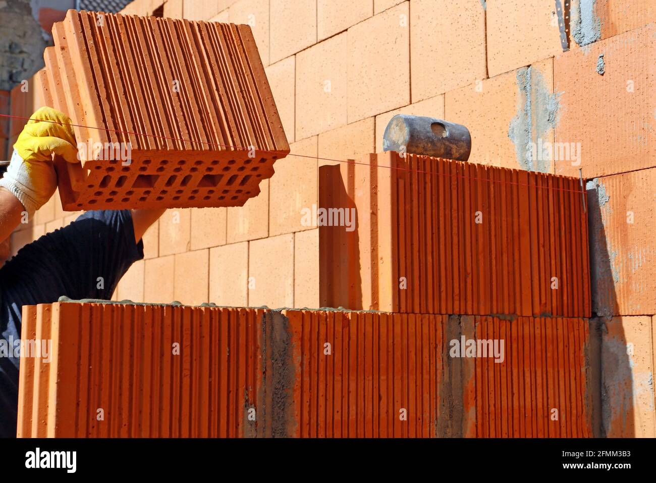 Construction worker (bricklayer) works on the construction site Stock ...