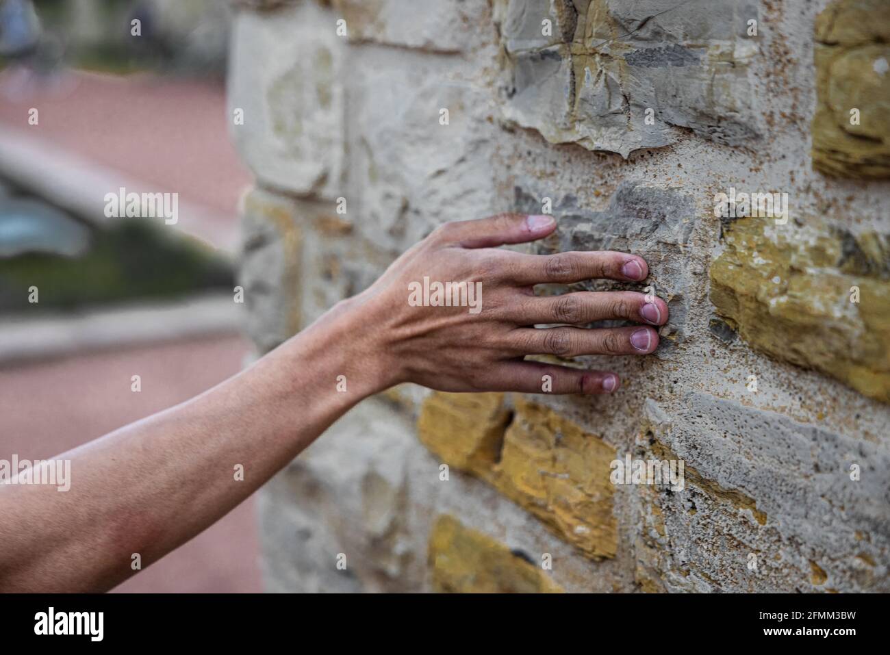 Male hand touching an exterior wall with a rough surface Stock Photo ...