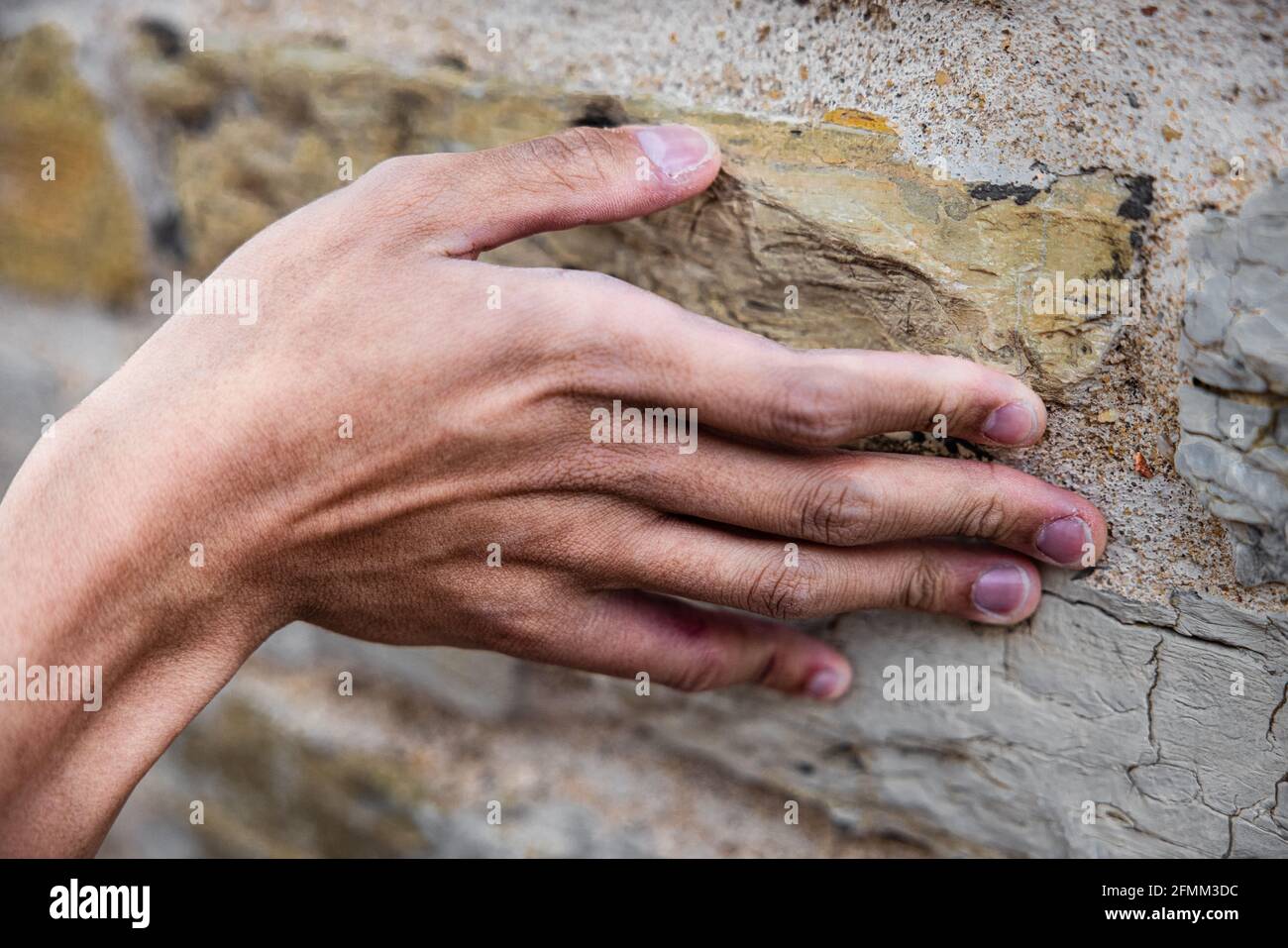 Closeup of a hand touching a weathered stone surface Stock Photo - Alamy