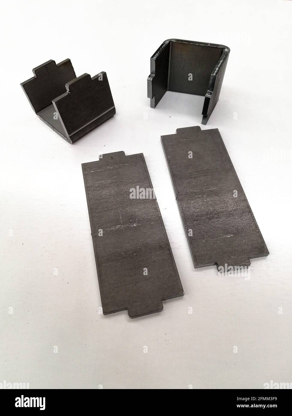 Vertical shot of parts before and after bending comparison on a white ...