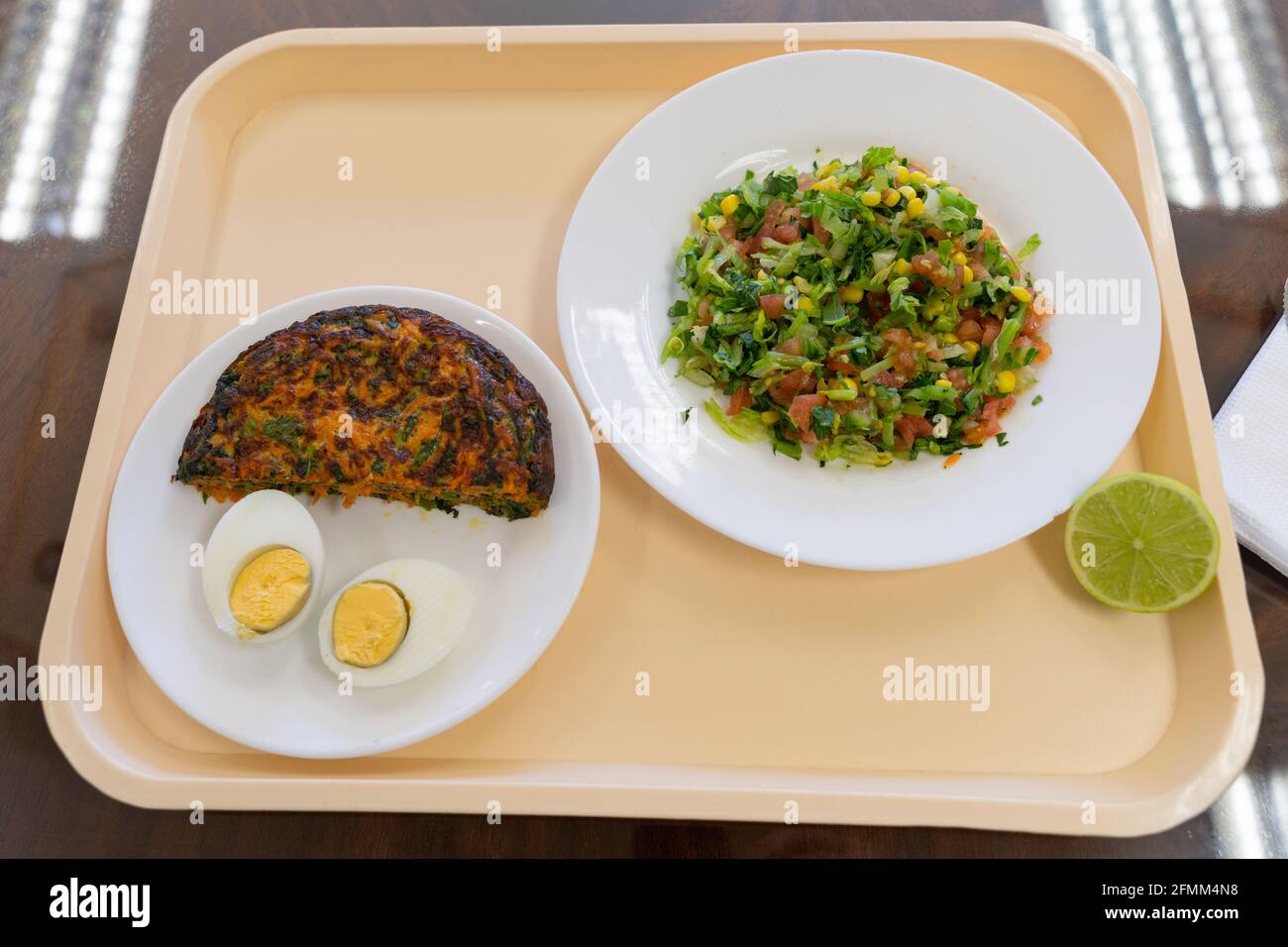 Tray menu with carrot omelette, boiled egg and salad plates. Lunch ...