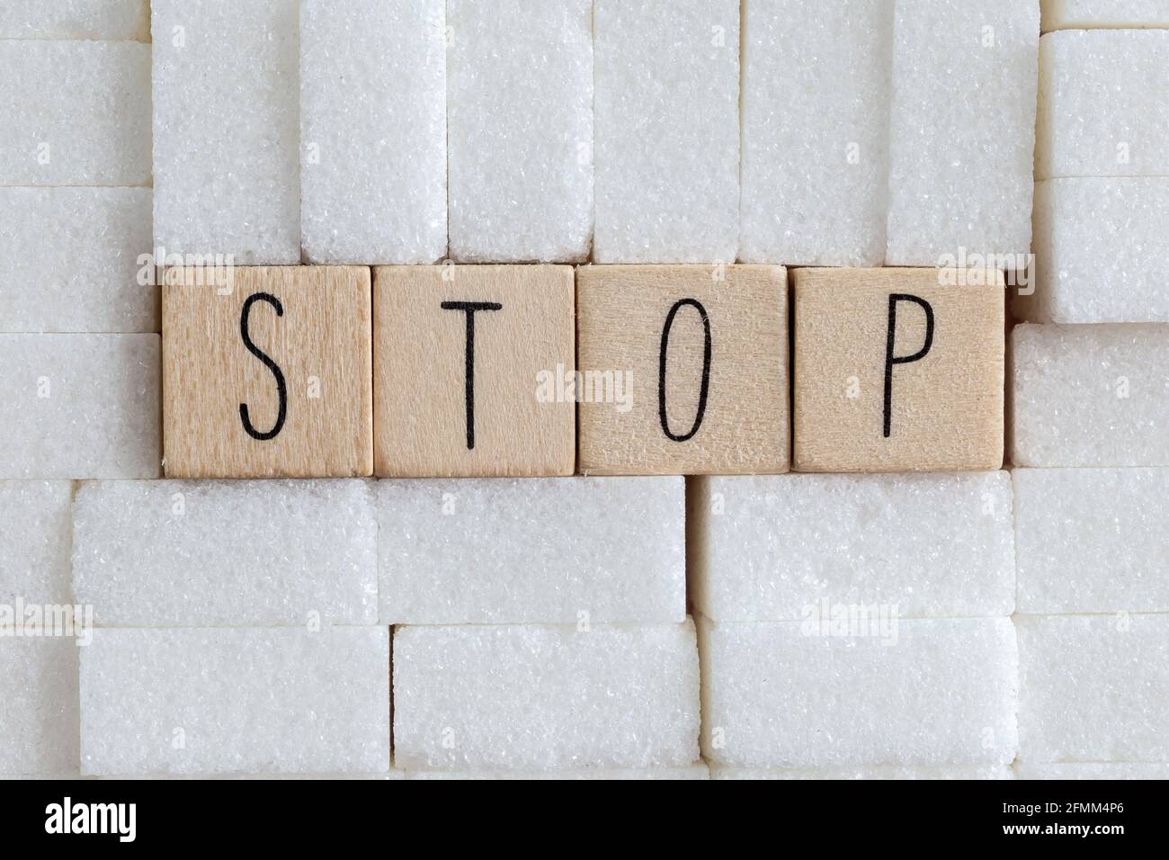 Pile or wall of sugar cubes and stop word in block letters as advise on ...