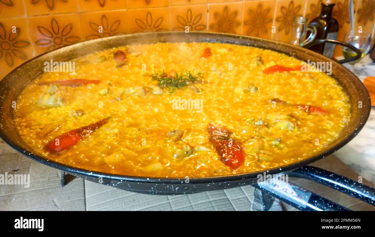Cooking Rice paella with rabbit. Typical Spanish dish Stock Photo - Alamy