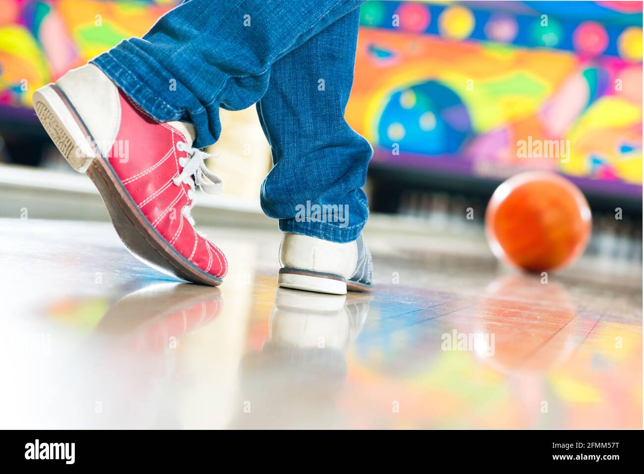 Young man in bowling alley having fun, the sporty man playing a bowling ...