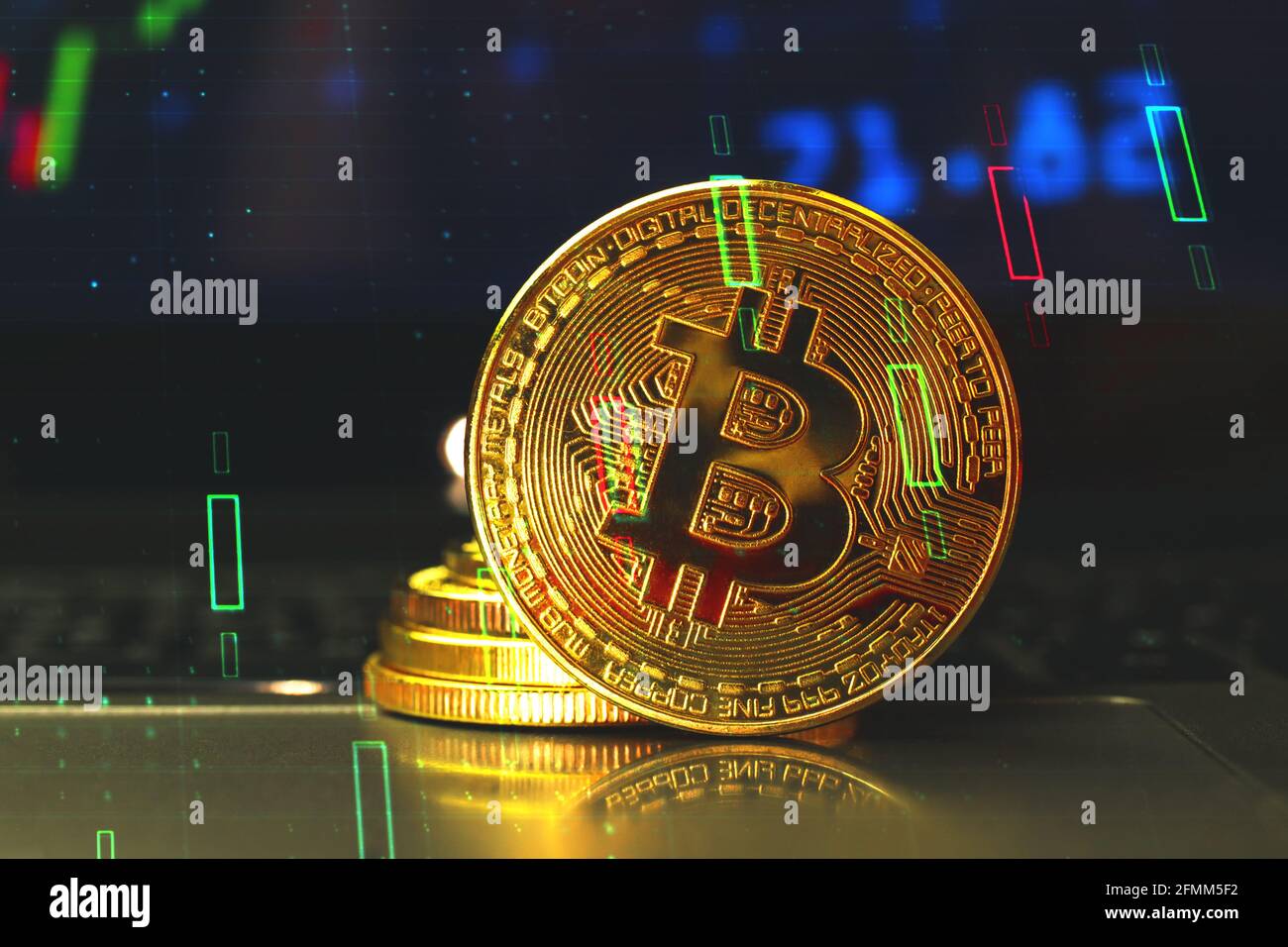 Bitcoin coin with chart stock graphs on background, close-up view of ...