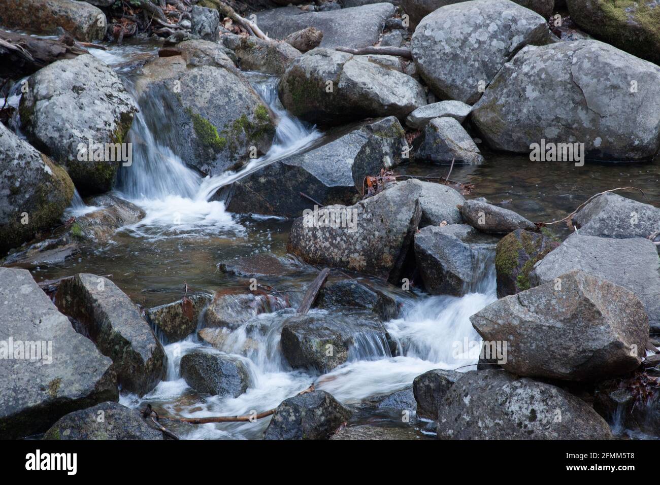 Stream cascading over rocks and stones Stock Photo - Alamy