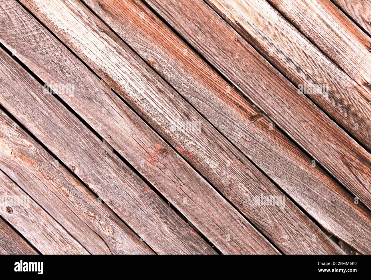 diagonal slanted barn wall siding boards weathered faded and worn as an ...