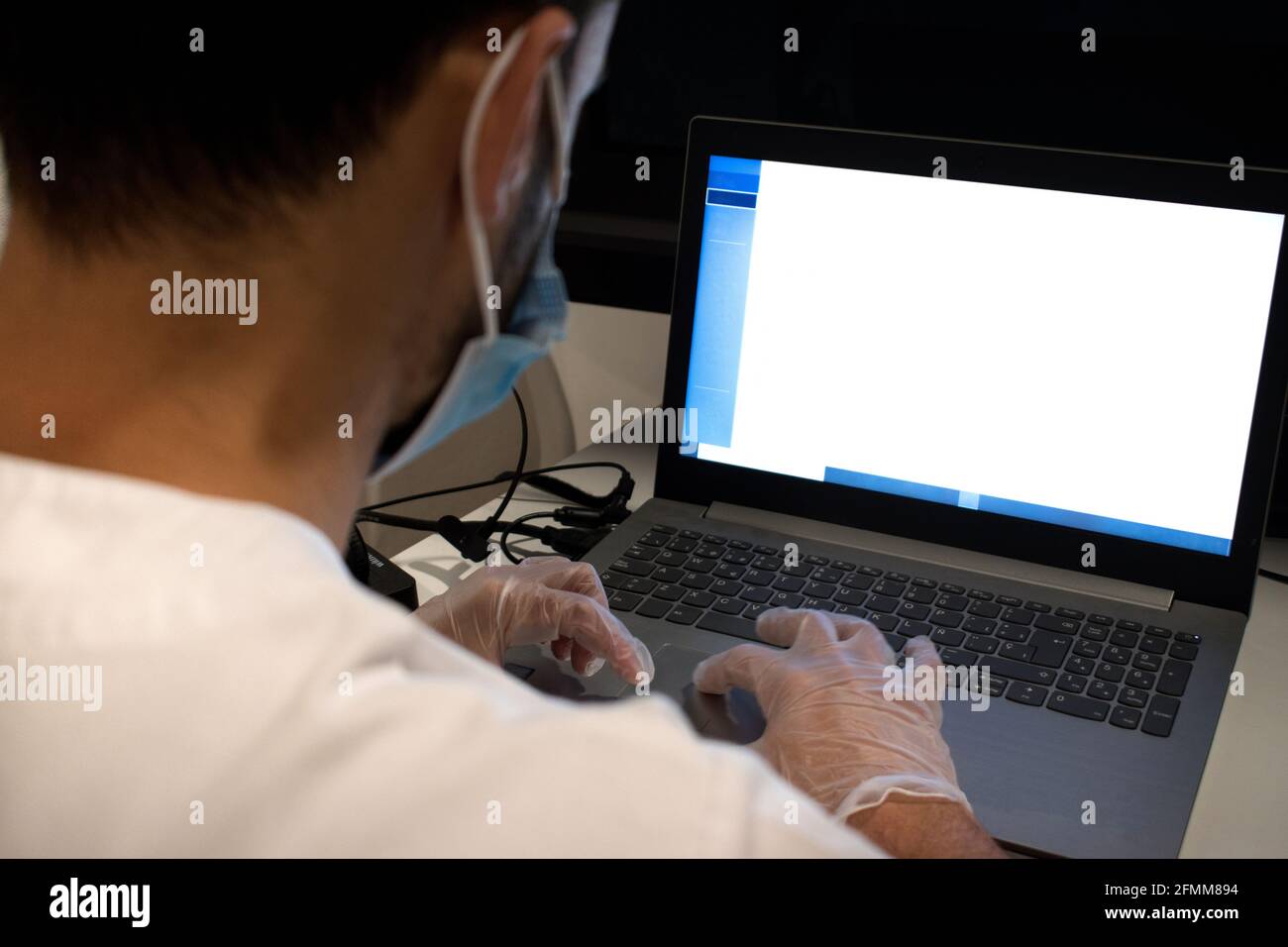 Doctor using computer from behind hi-res stock photography and images ...