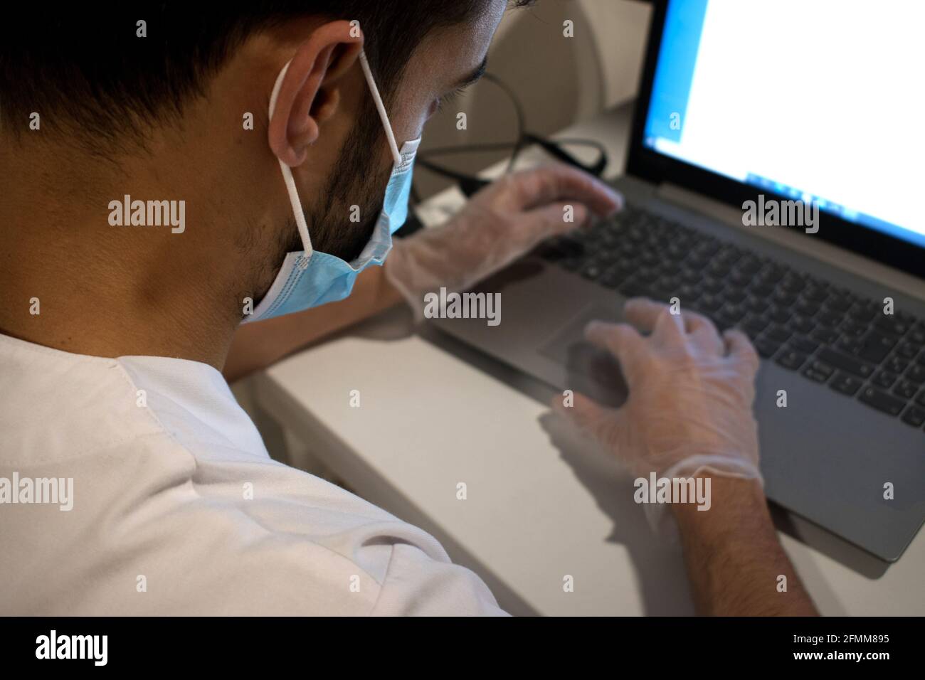 Doctor using computer from behind hi-res stock photography and images ...
