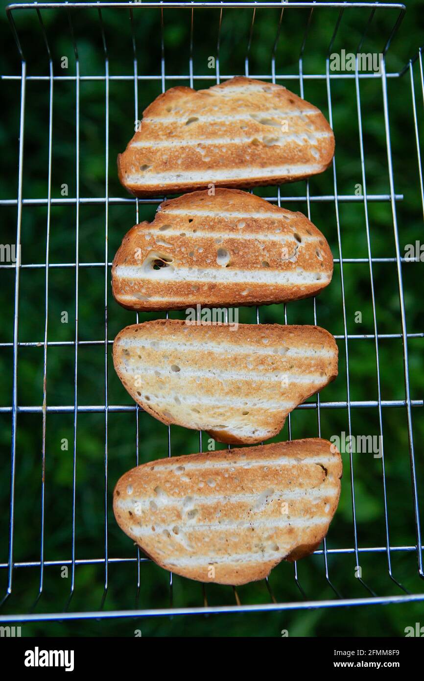 Grilled crispy toast on the wire rack. Outdoor recreation. Bonfire ...