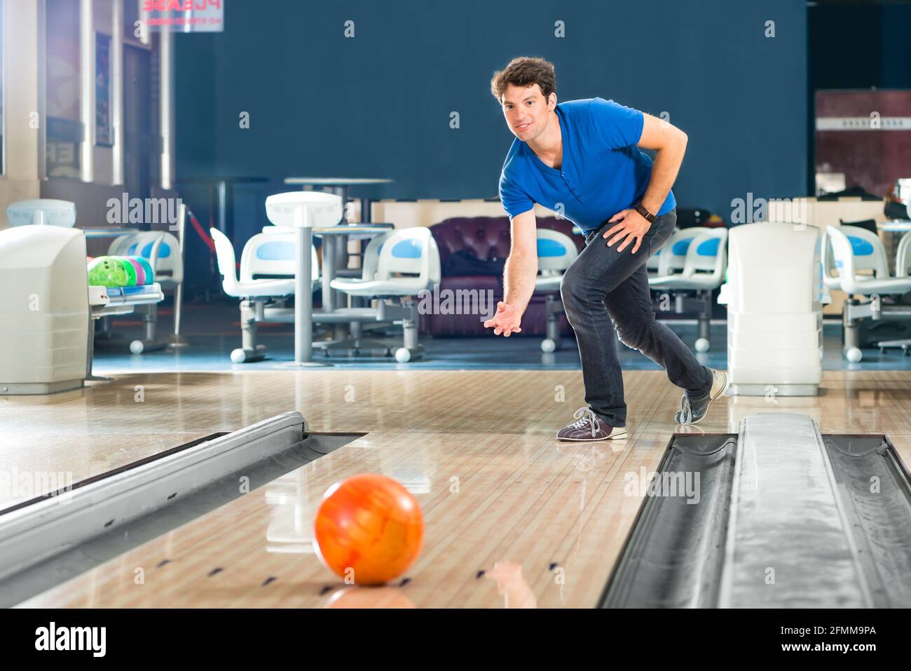 Group of friends in a bowling alley having fun, the girls cheering then ...