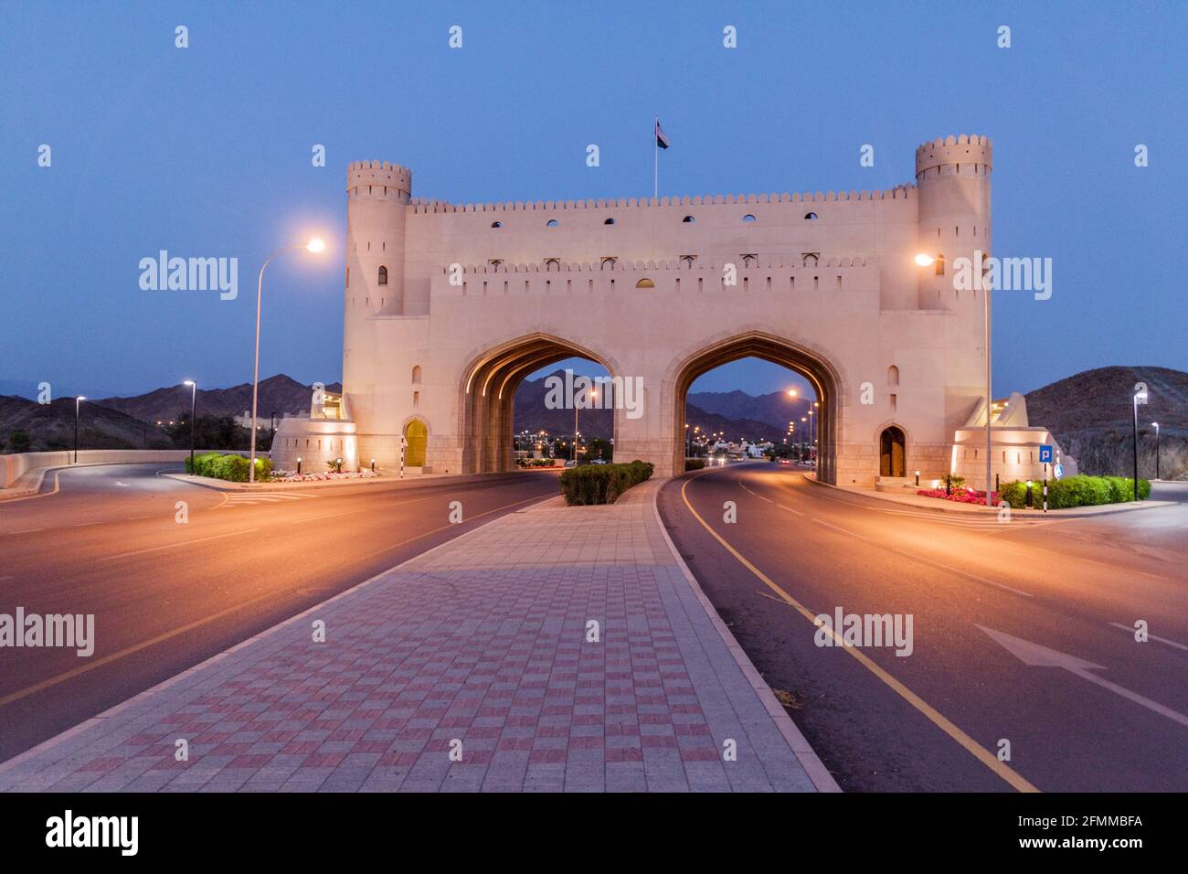 Evening of the road passing through the Bahla Gate in Oman Stock Photo ...