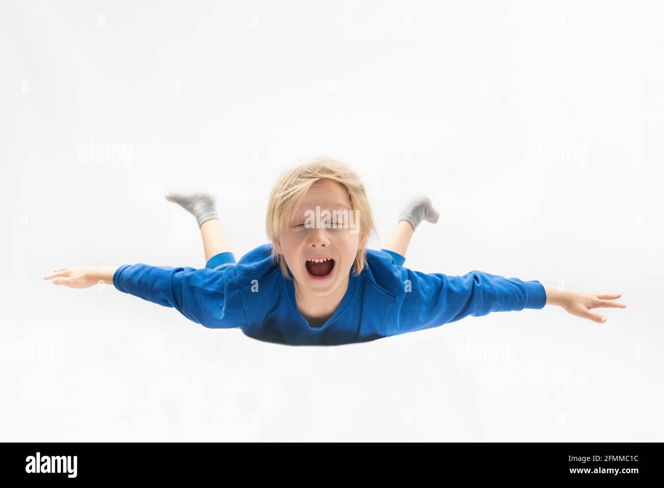 Little boy is flying, falling or floating in the dream. White ...