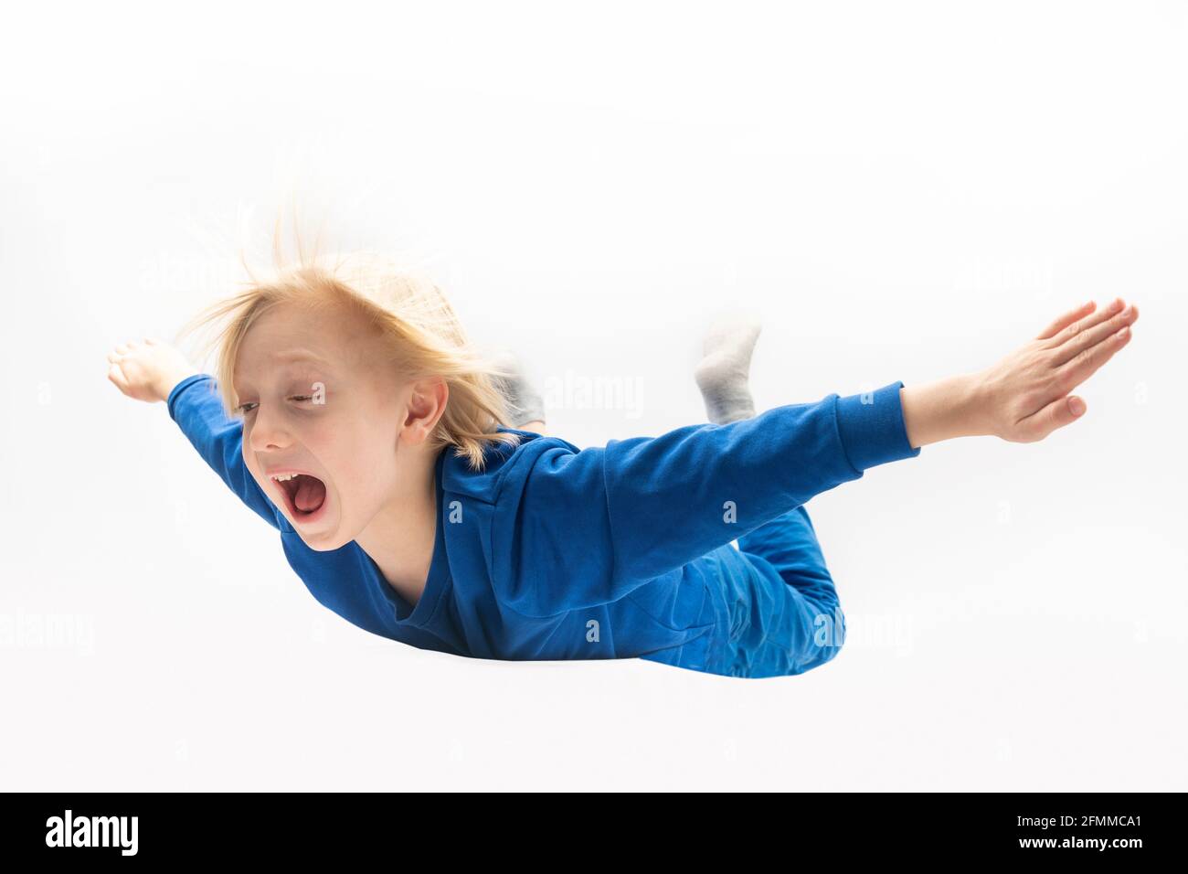Little boy is flying, falling or floating in the air. Flying in dream ...