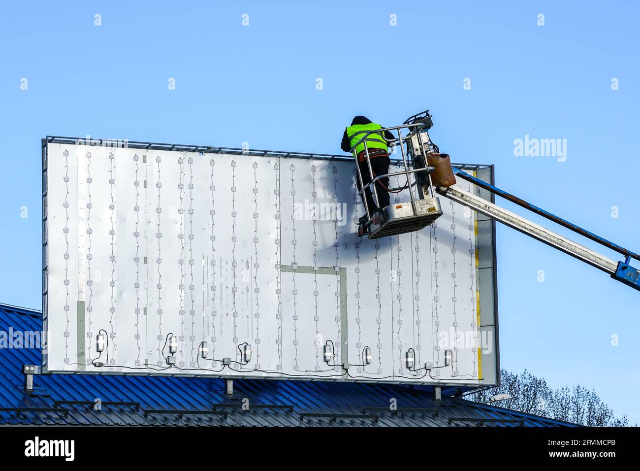 installation of a new large modern billboard with LED lighting on a ...