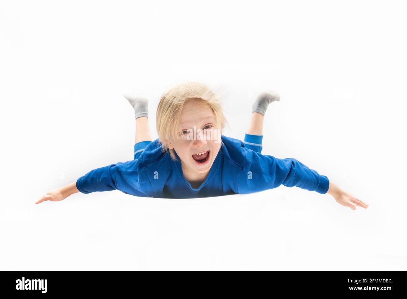 Scared little blond boy is falling from height. Free fall. White ...