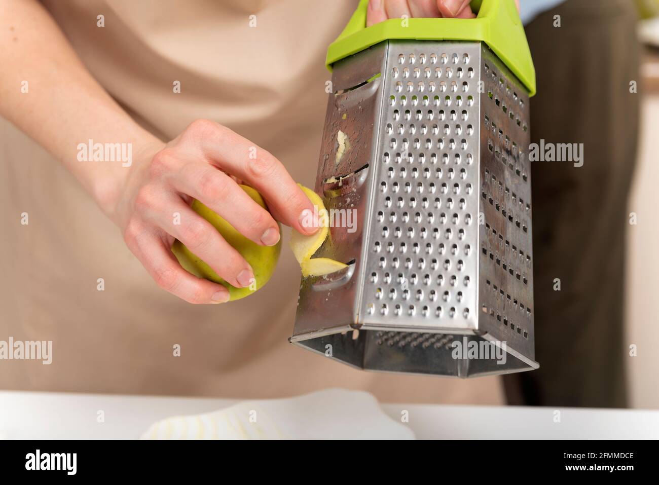 Chef's hands are grating the apple. Preparation of ingredients Stock ...
