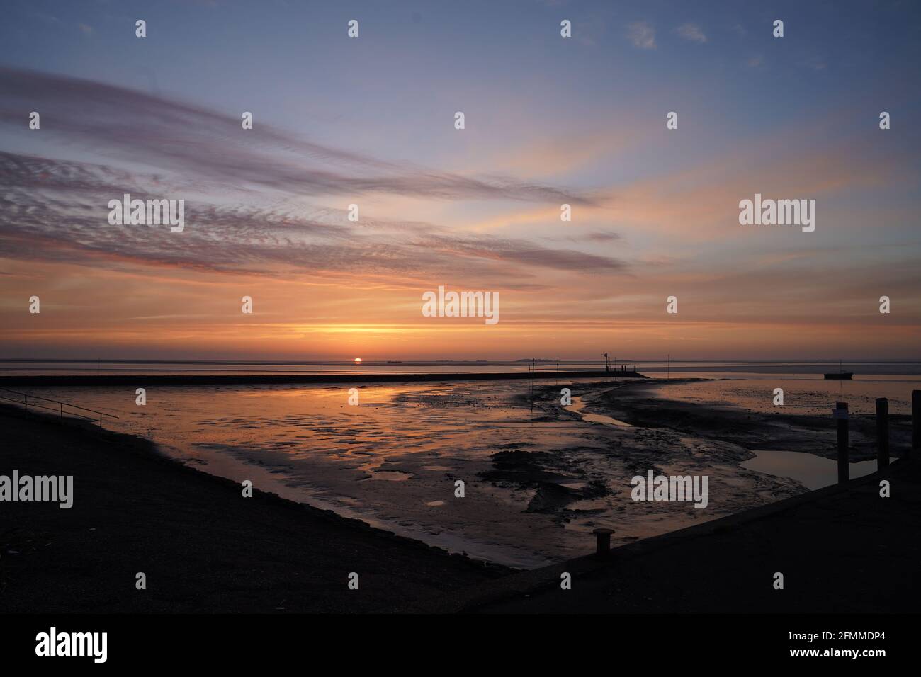 Pellworm, Germany. 10th May, 2021. The sun sets over the North Sea off ...