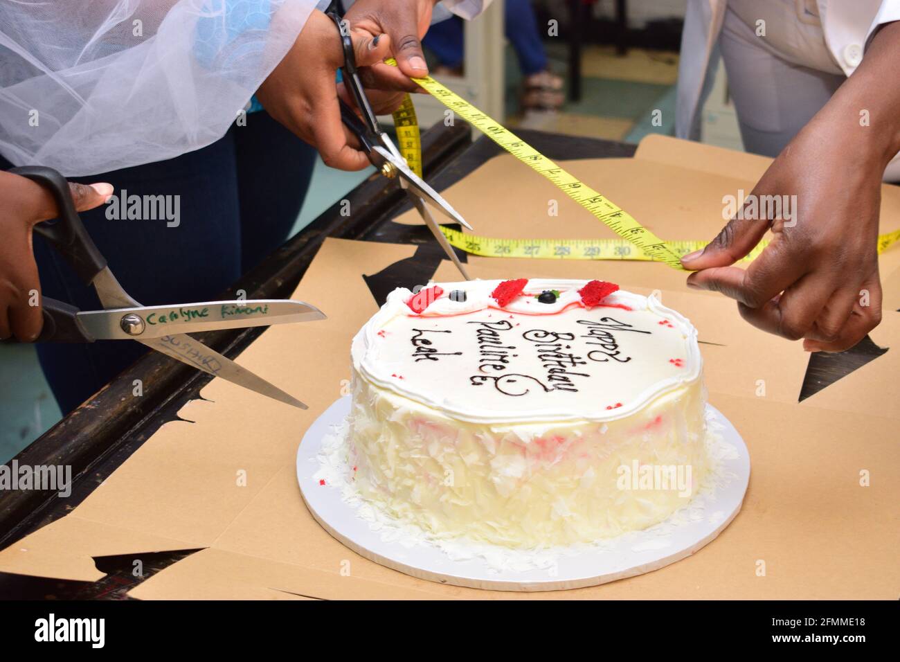 birthday cake measured with a measuring tape Stock Photo - Alamy