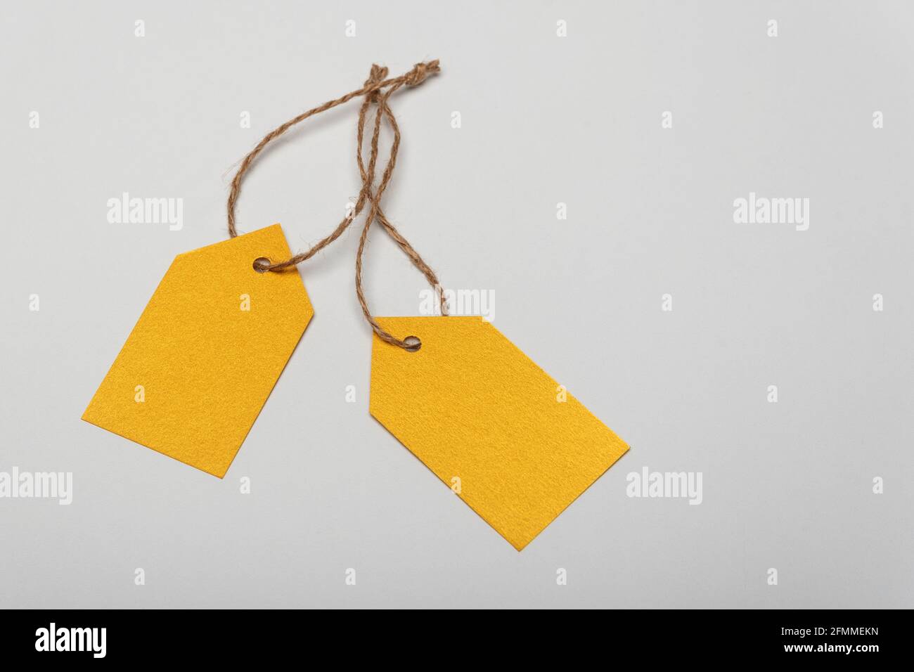 Yellow blank clothing tags, white background. Labels blank mockup Stock ...