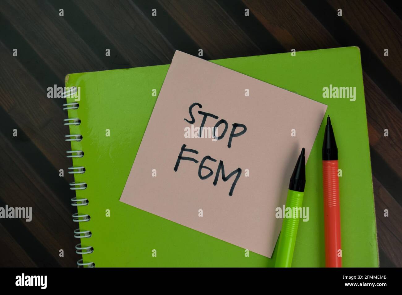 Stop FGM write on sticky notes isolated on Wooden Table Stock Photo - Alamy