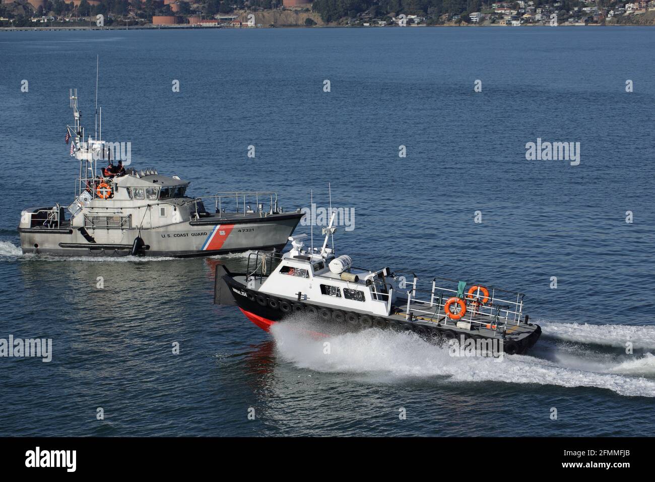 US Coast guard boat and motor boat crossing Stock Photo - Alamy