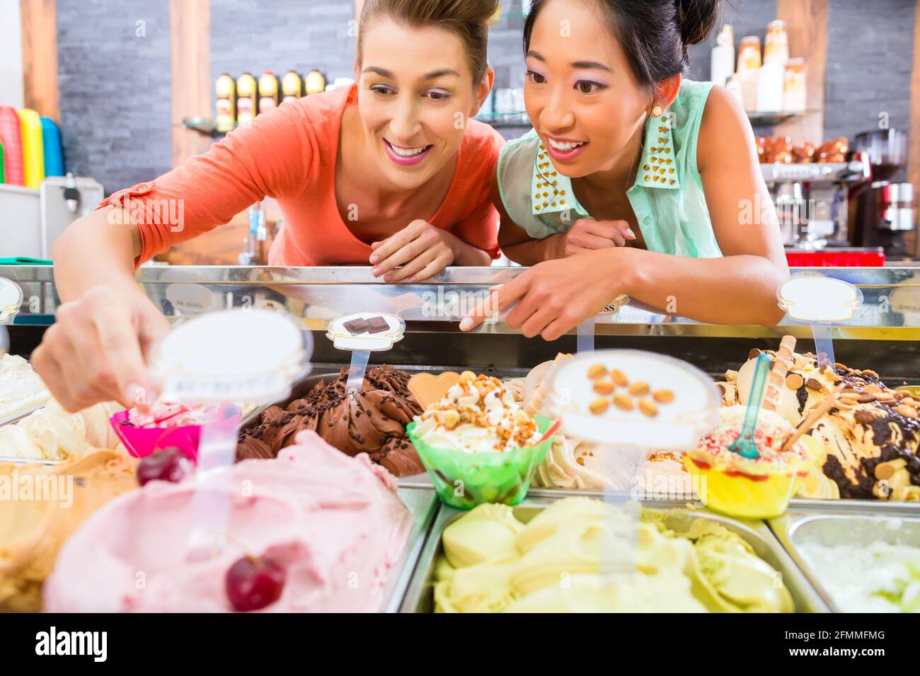 Friends holding ice cream cone hi-res stock photography and images - Alamy