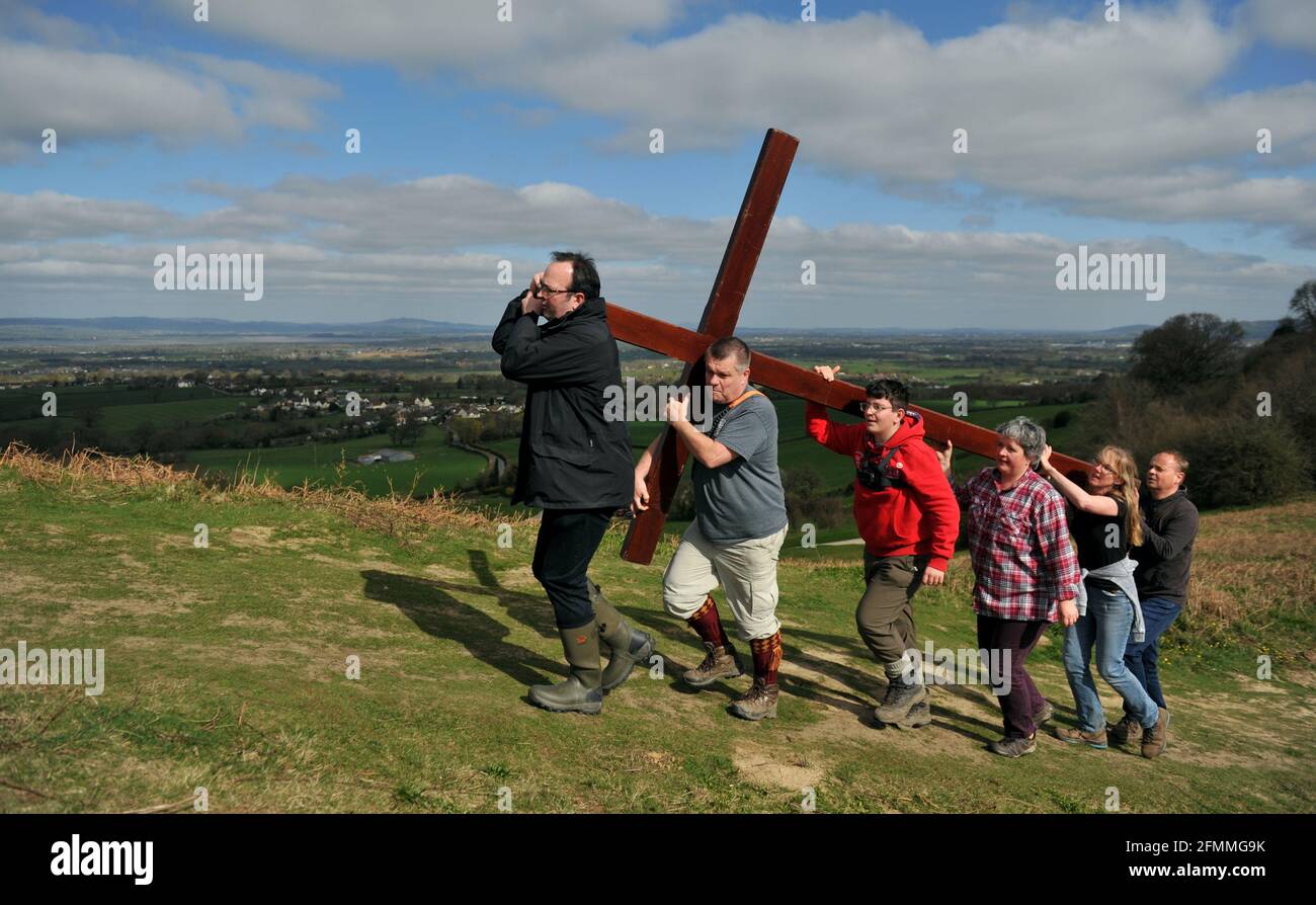 Carrying a wooden cross up Cam Peak on Good Friday before Easter Sunday ...