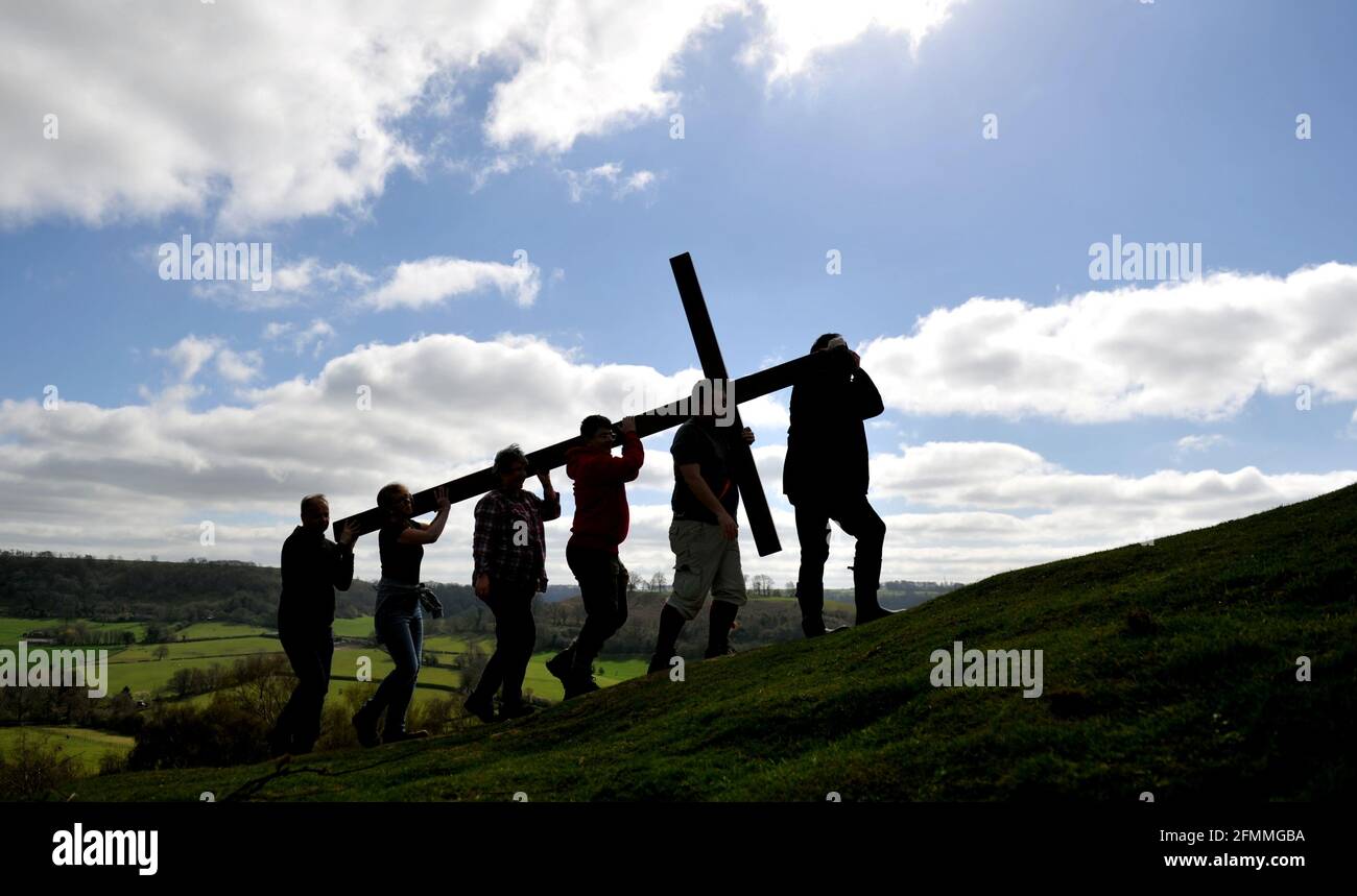 Carrying a wooden cross up Cam Peak on Good Friday before Easter Sunday ...