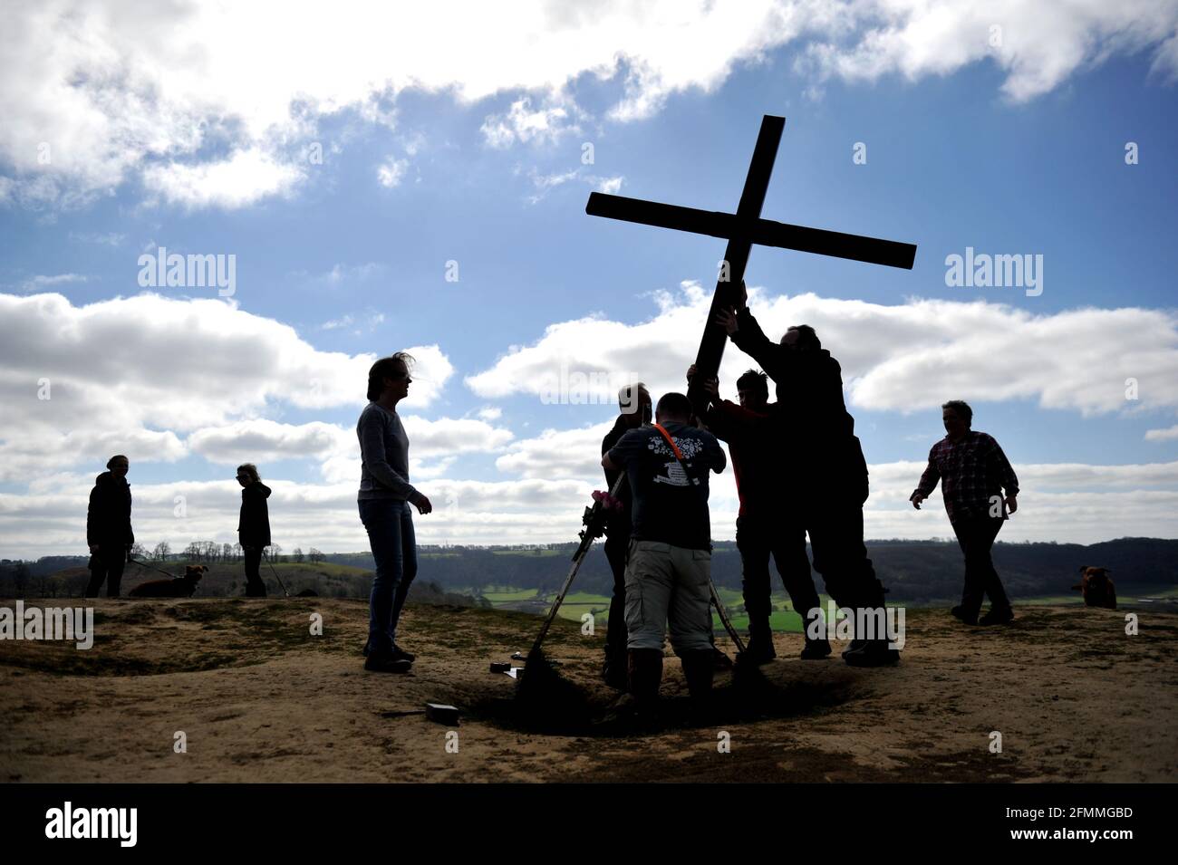 Carrying a wooden cross up Cam Peak on Good Friday before Easter Sunday ...